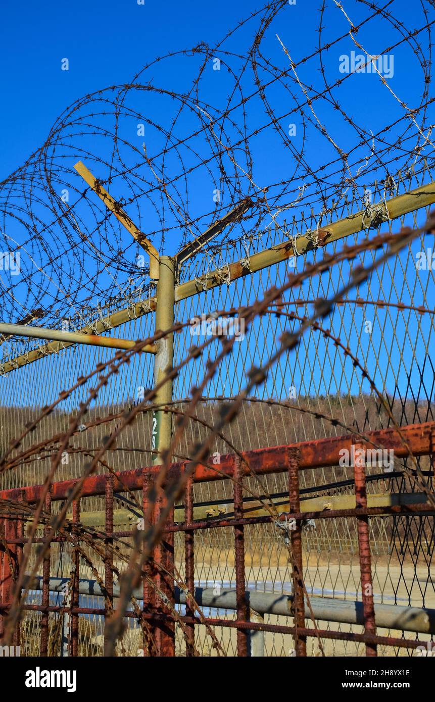 Vertical shot of a barbed wire fence of the Goseong Unification ...