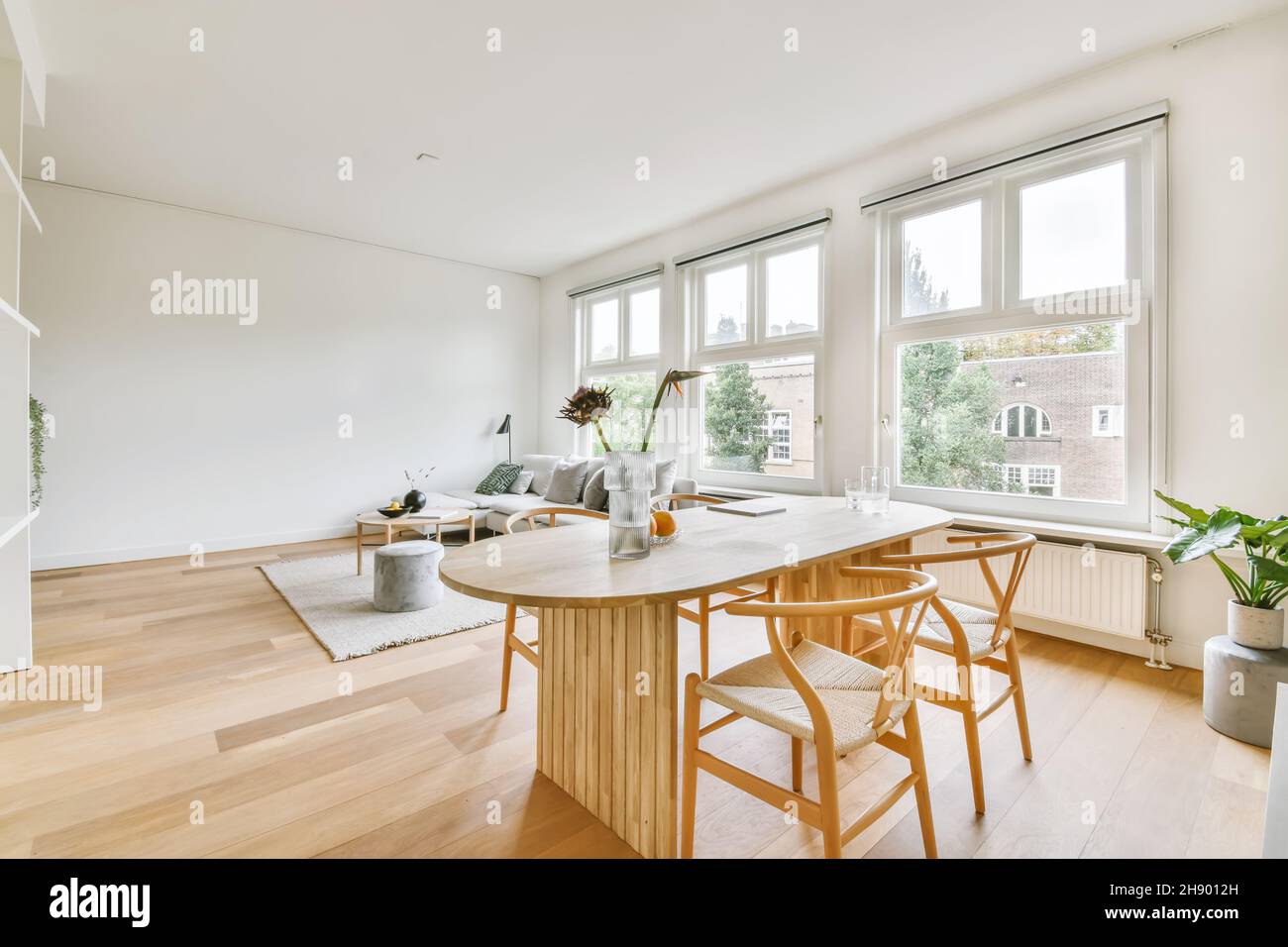 Combined dining area with living room with a huge soft white sofa Stock ...