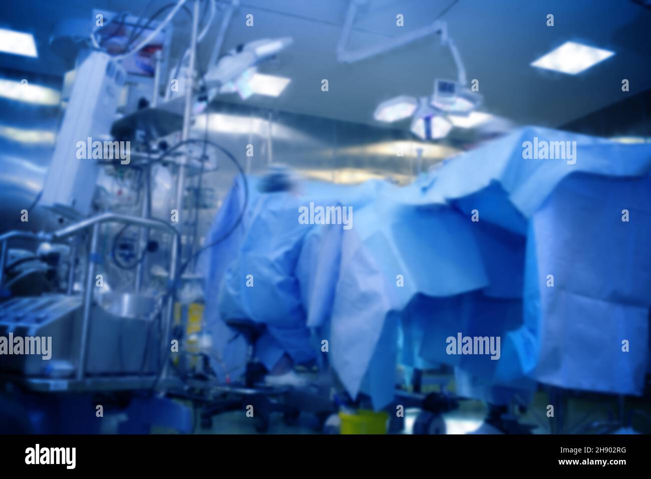 Blurred operating room with covered table and equipment, unfocused ...