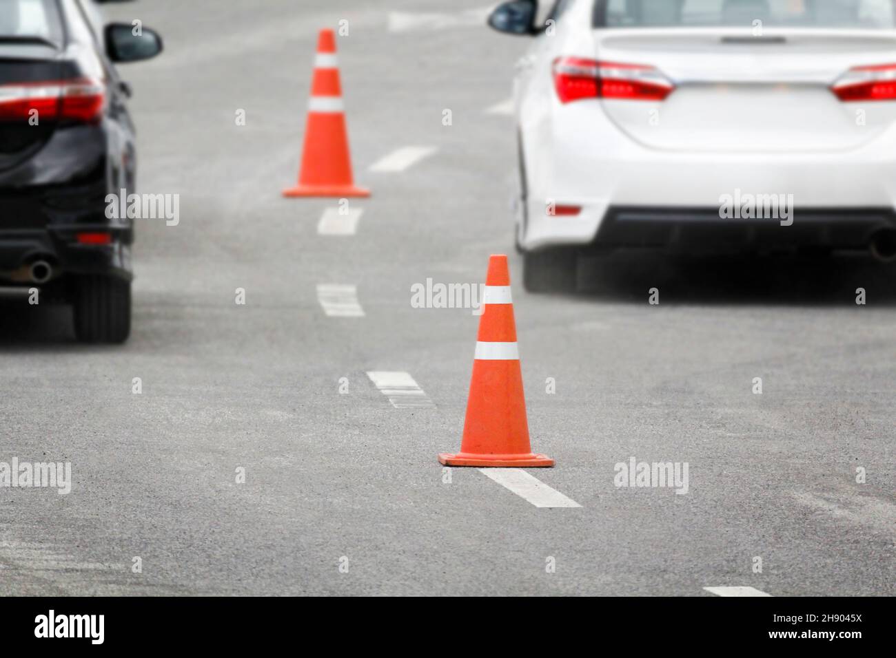 traffic cone in rush hour , focus at cone Stock Photo - Alamy
