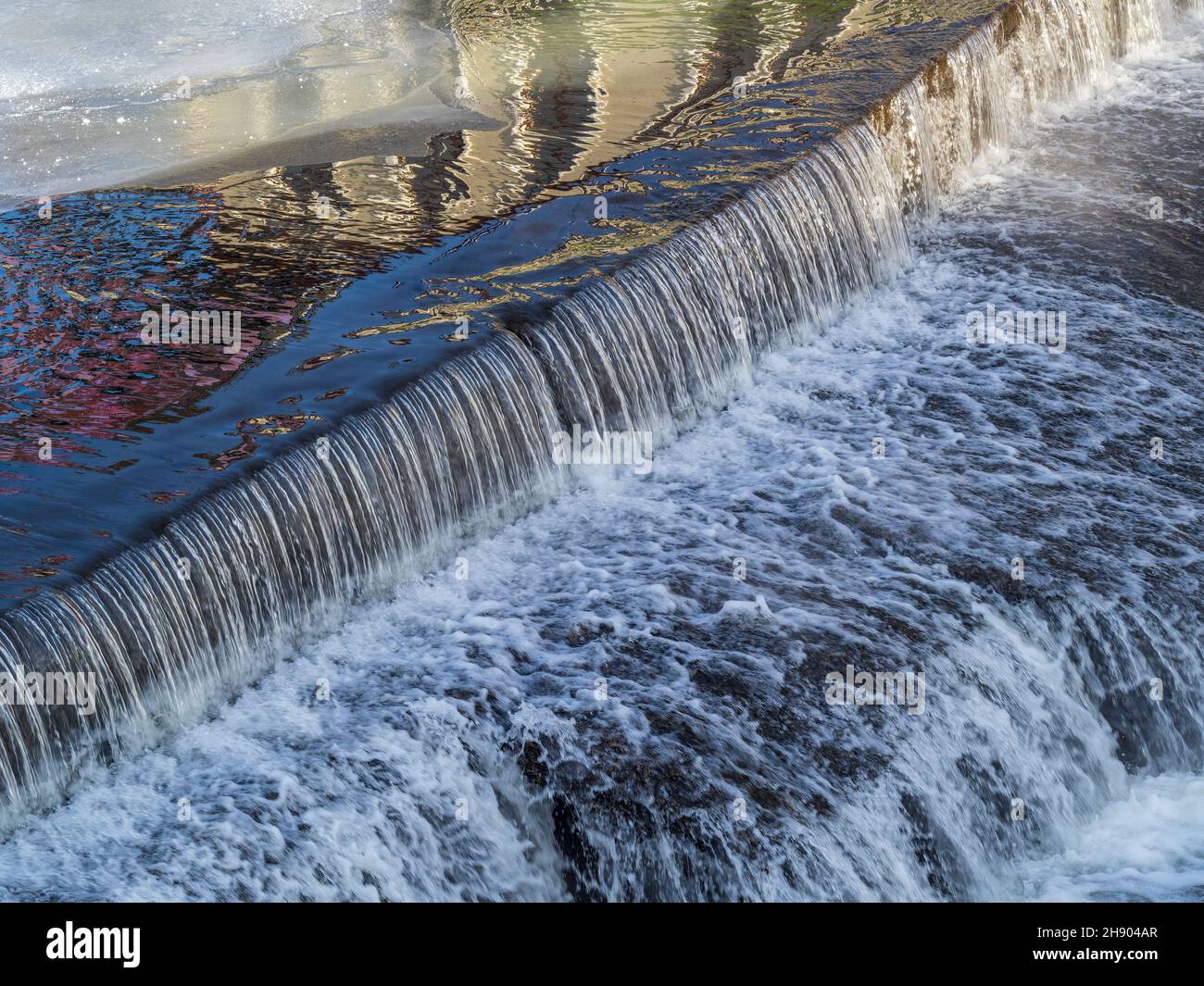 A small flat cascade in a calm river. Water background Stock Photo - Alamy