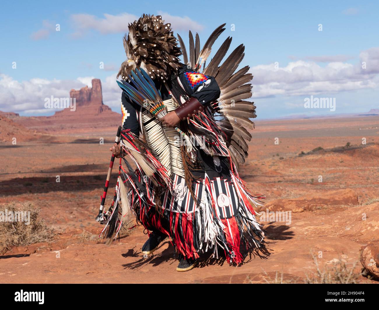 Close up of Native American man wearing a spotted feather headdress ...