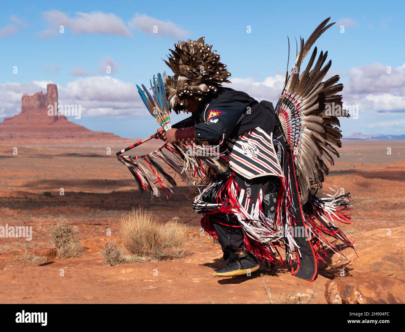 Native American pow wow dancer dancing in crouched position in full ...