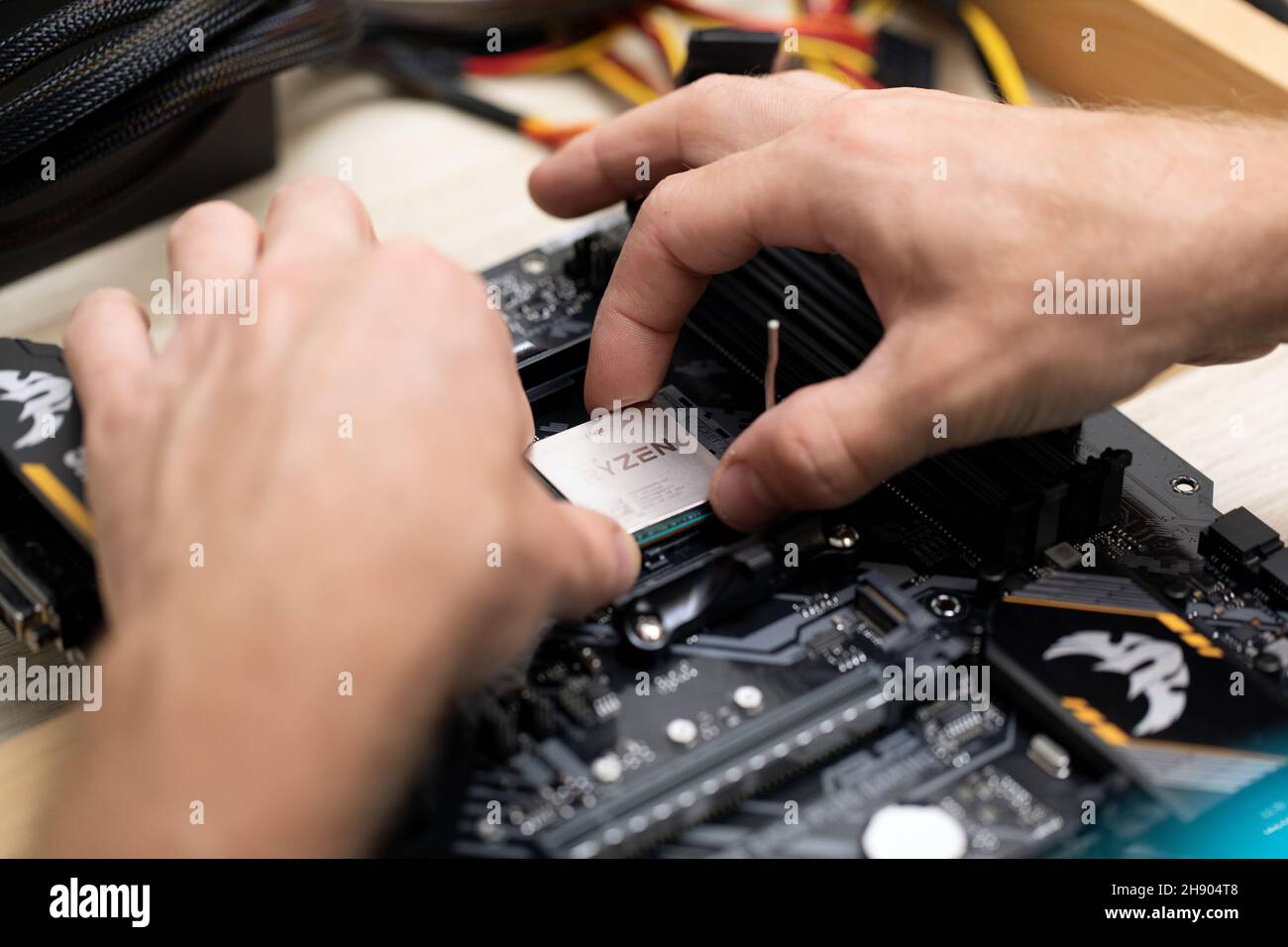 Close up of electronic engineer installing Ryzan microprocessor. Maintenance computer cpu ...