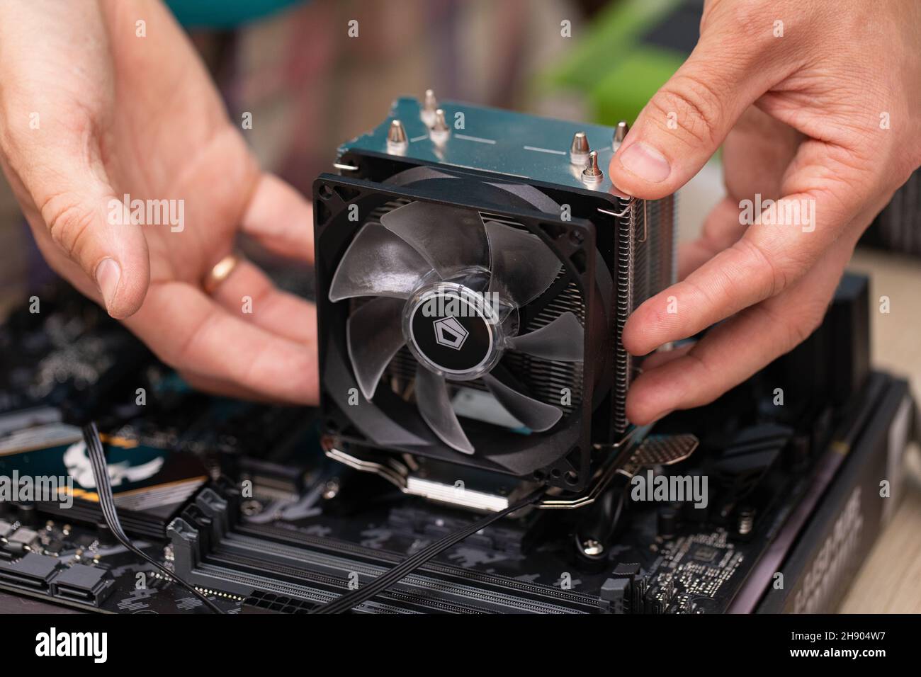 Engineer man installing aluminum heat sink install at computer circuit board for cooling chips ...
