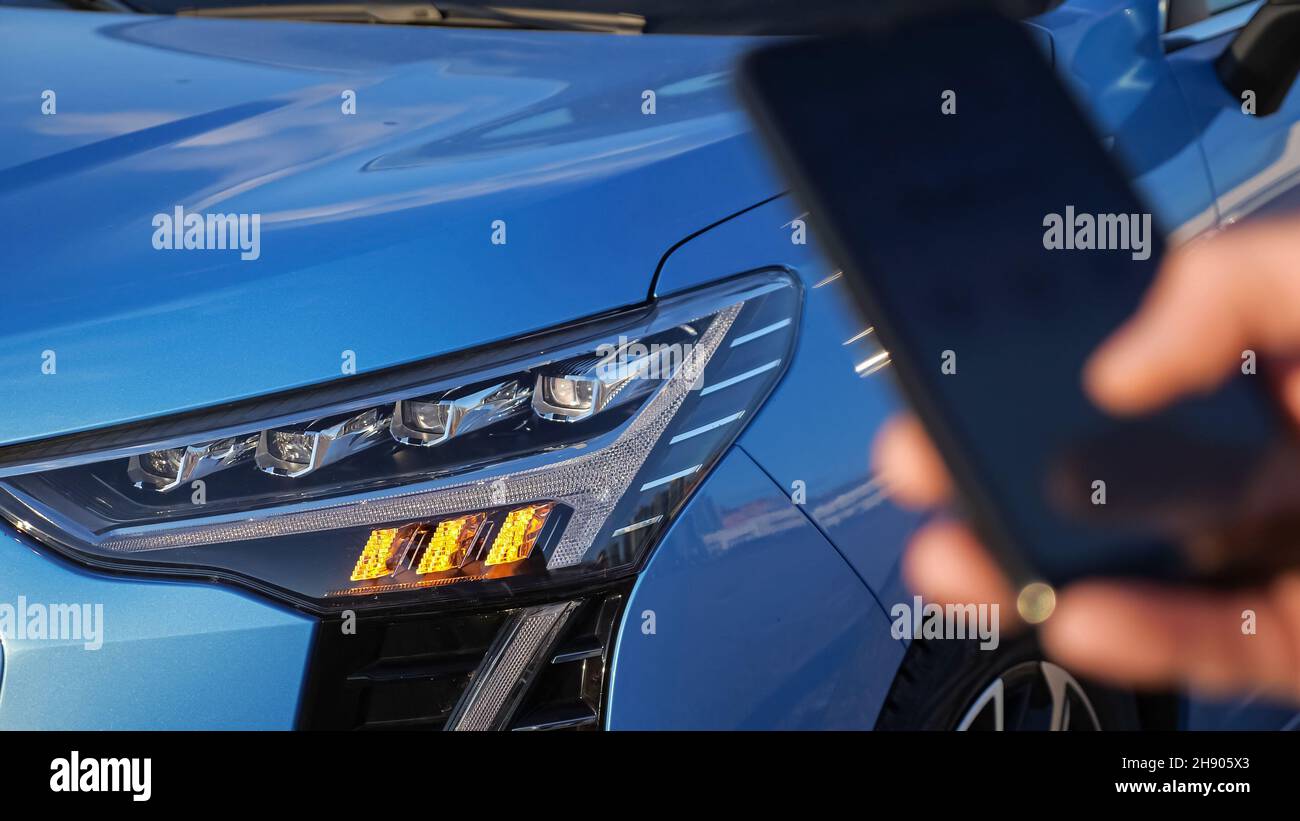 Driver controls car and removes signalling using smartphone Stock Photo ...