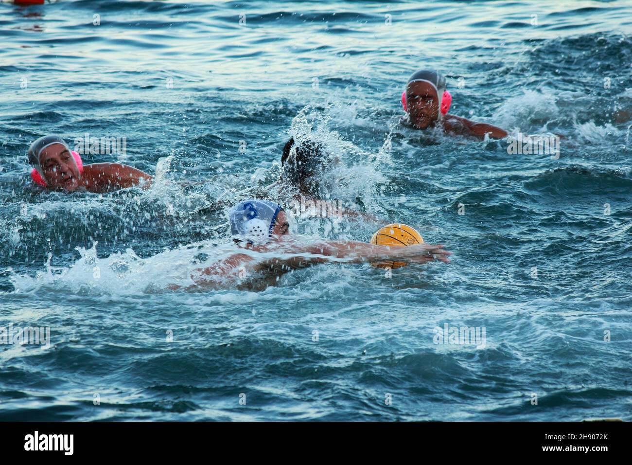 Waterpolo player in the water with ball Stock Photo - Alamy