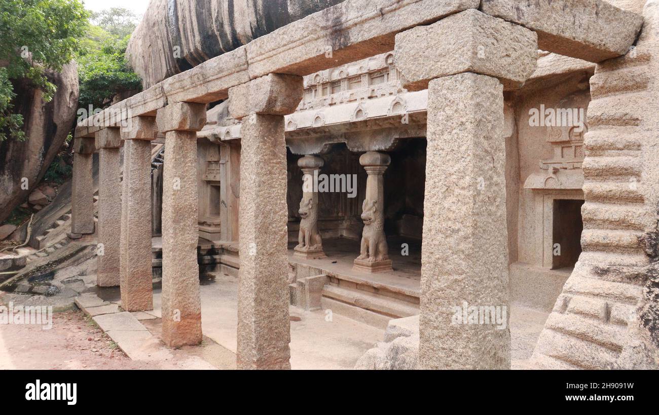 Cave stone hall carved in the rock with pillars in the background of ...