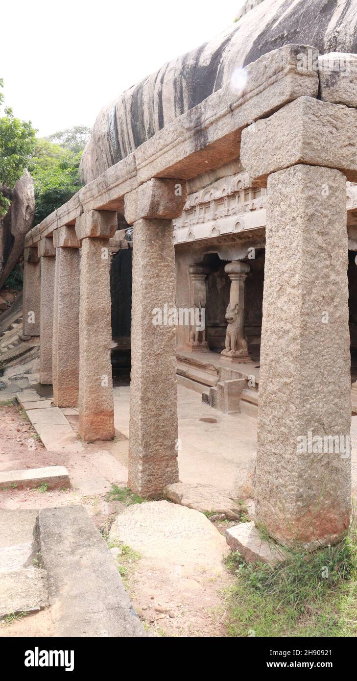 Cave stone hall carved in the rock with pillars in the background of ...