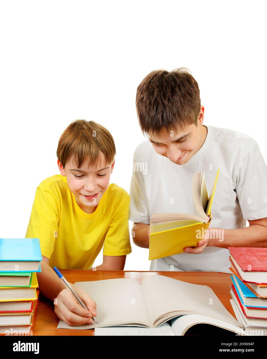 Brothers with the Books doing Homework on the White Background Stock ...