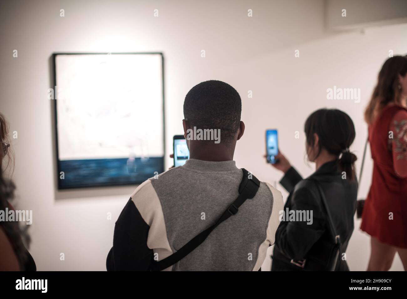 Group of people seen inside gallery Stock Photo - Alamy
