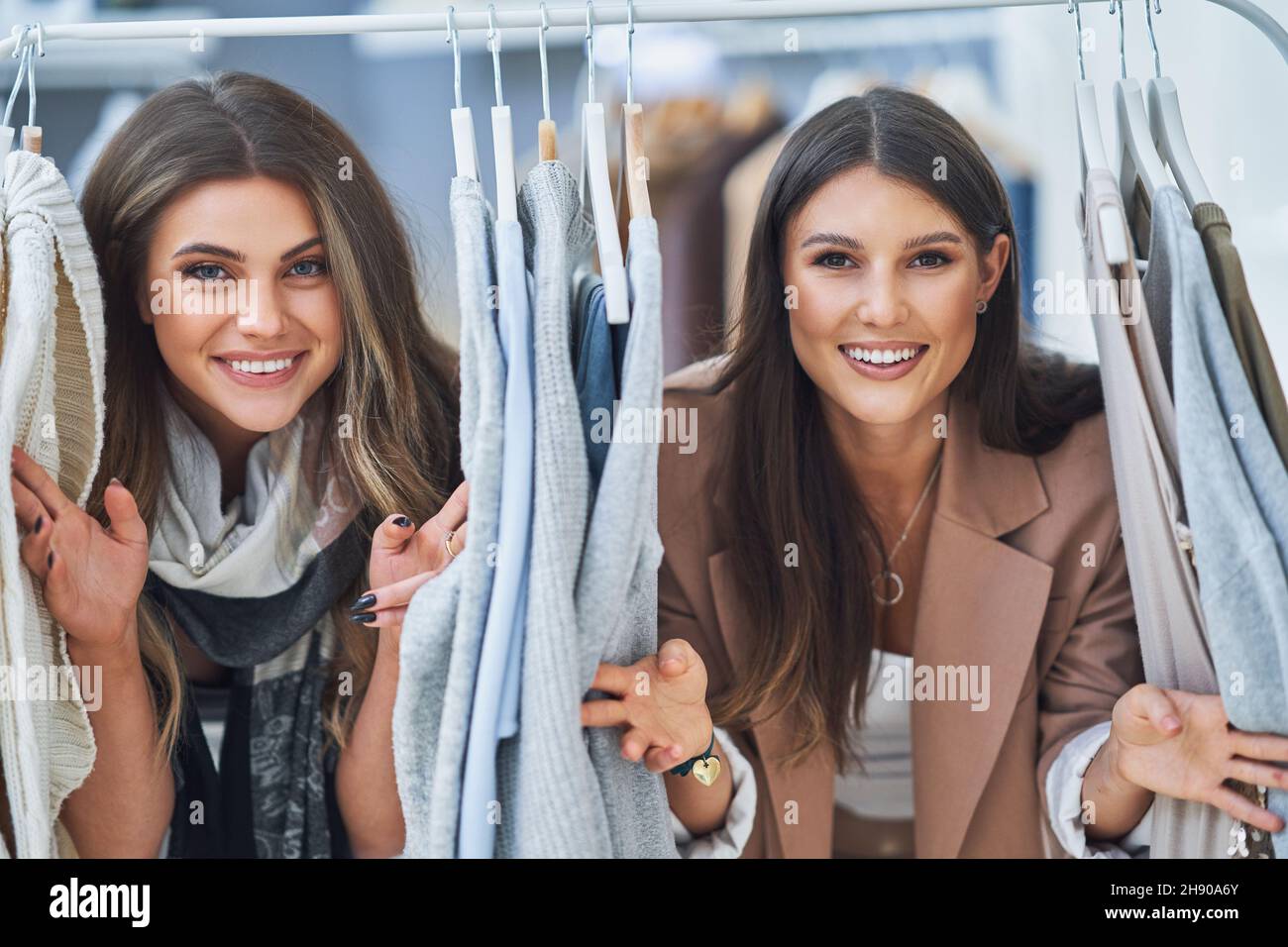 Two happy girls in clothes store during shopping Stock Photo - Alamy