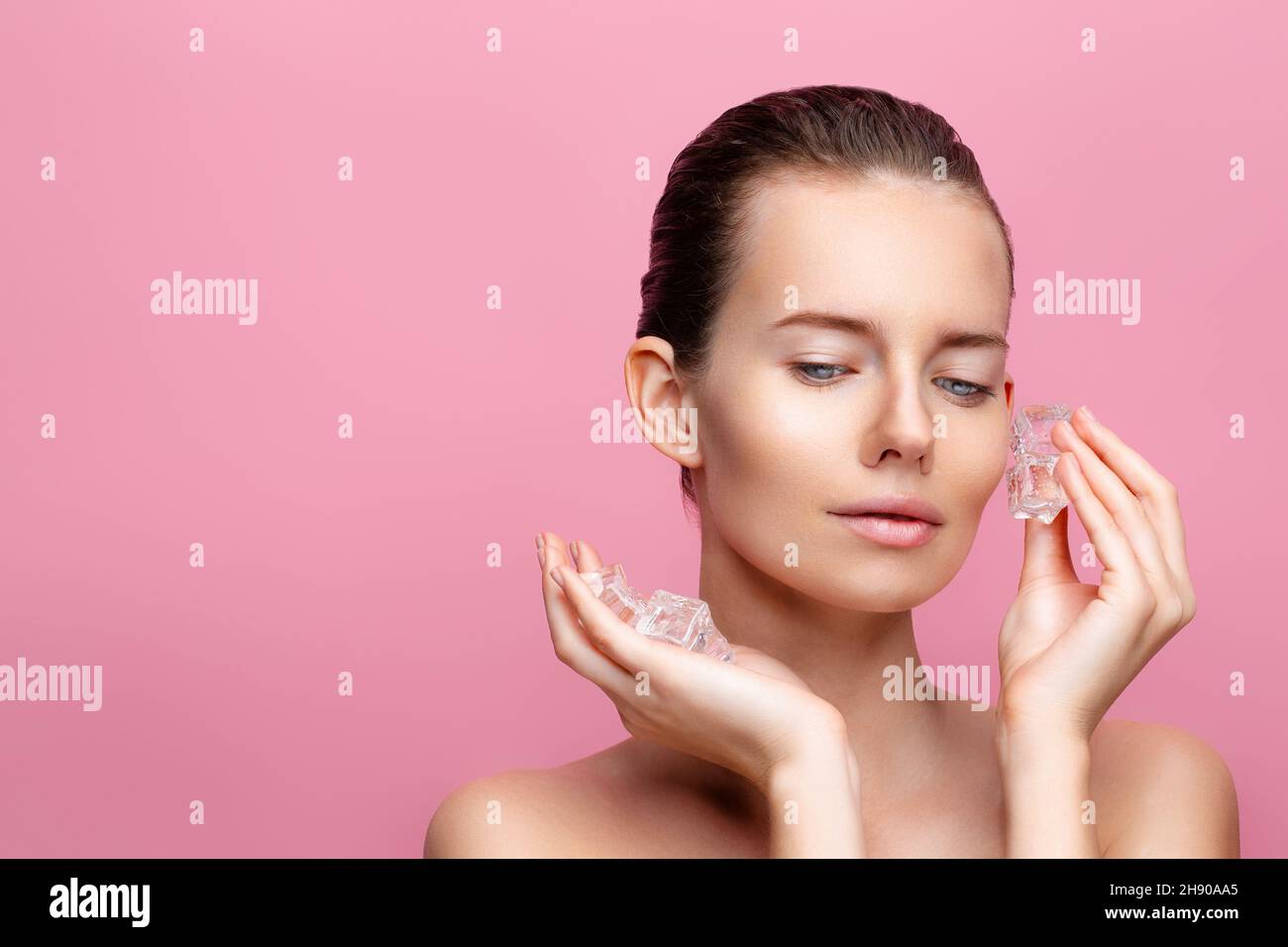 Beauty caucasian woman with healthy clean fresh skin applies Ice cubes ...