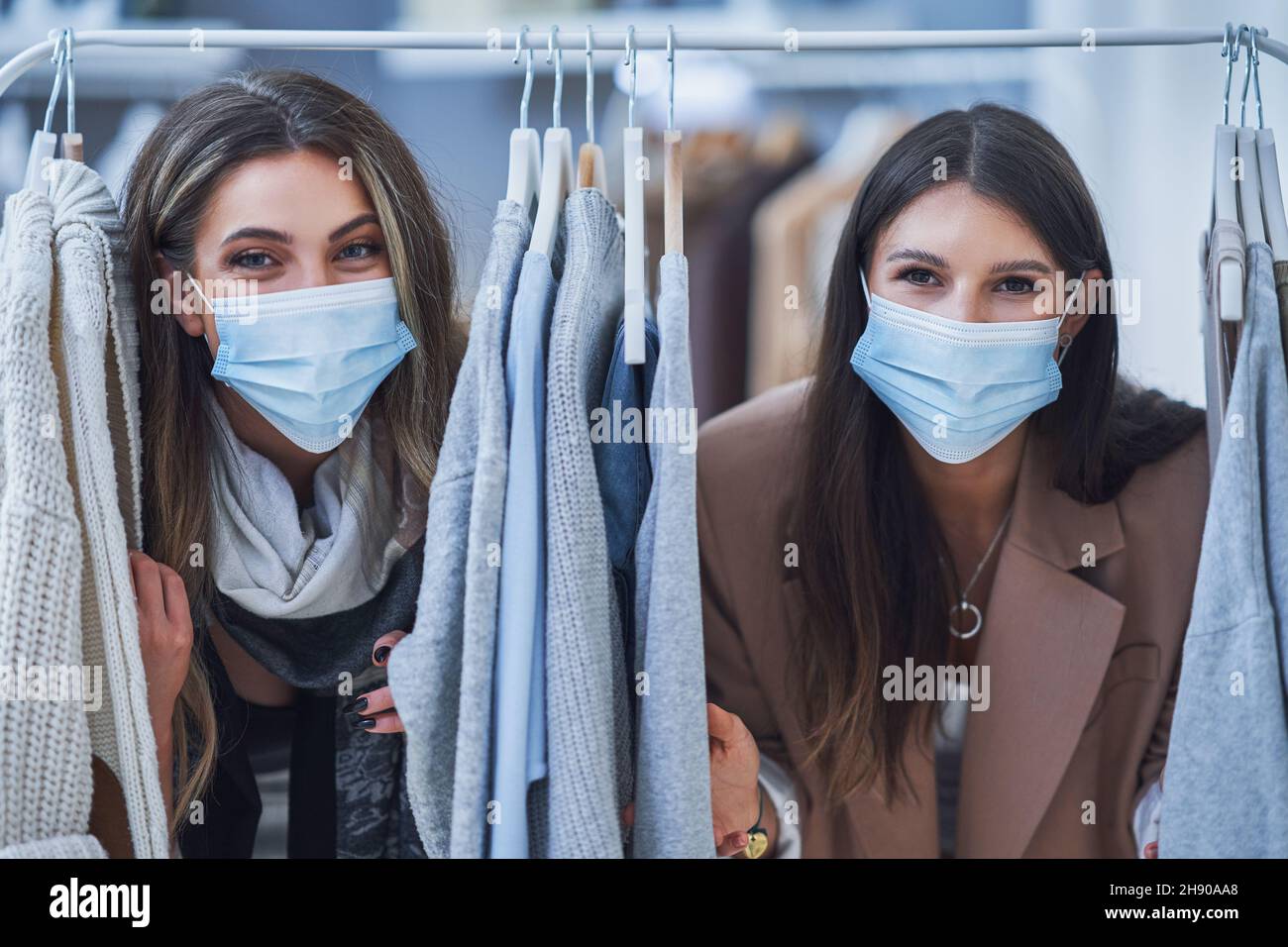 Two happy girls in clothes store during shopping Stock Photo - Alamy