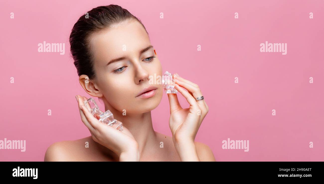 Beauty caucasian woman with healthy clean fresh skin applies Ice cubes ...