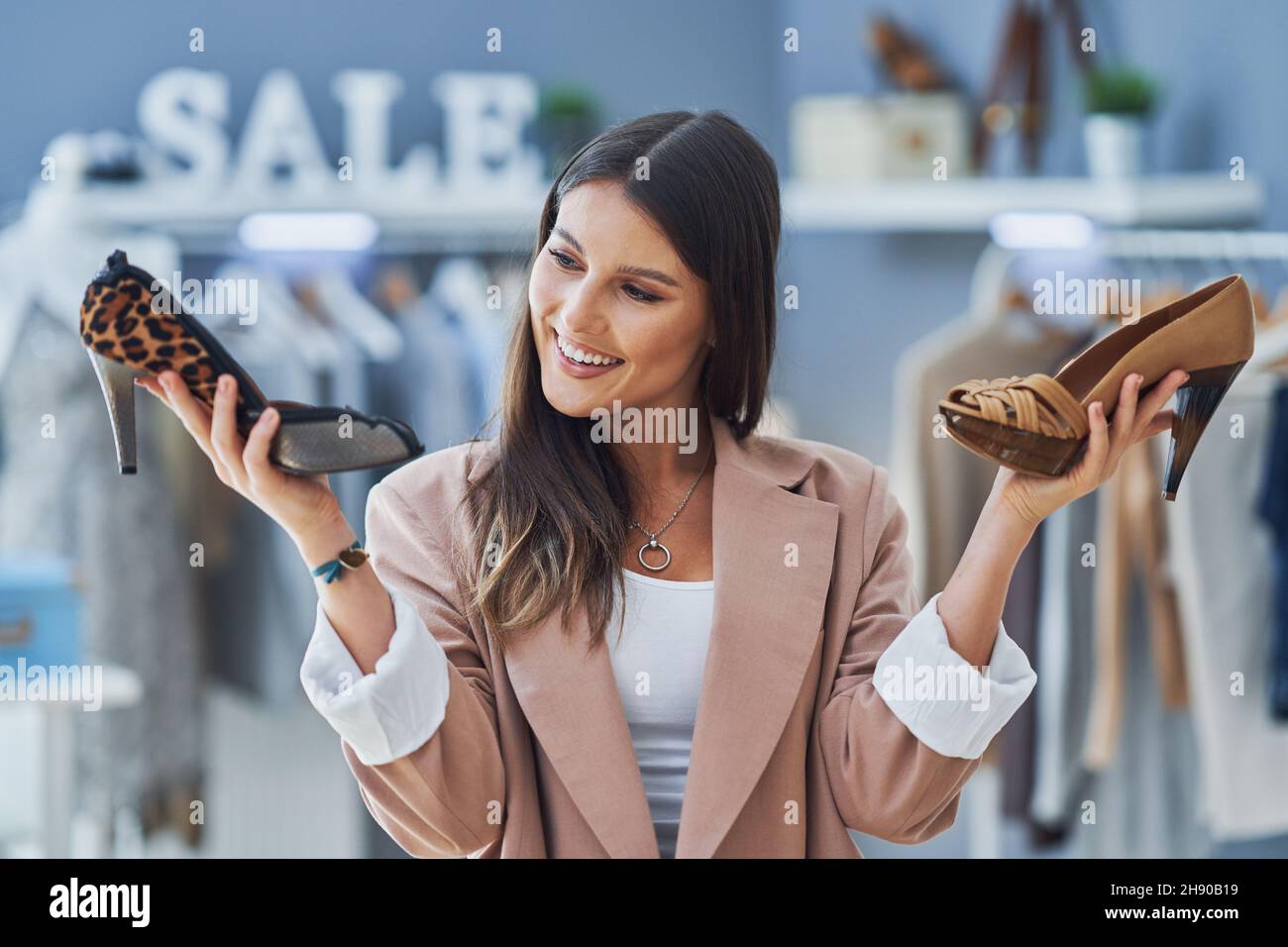 Woman choosing shoes in shoe store hi-res stock photography and images ...