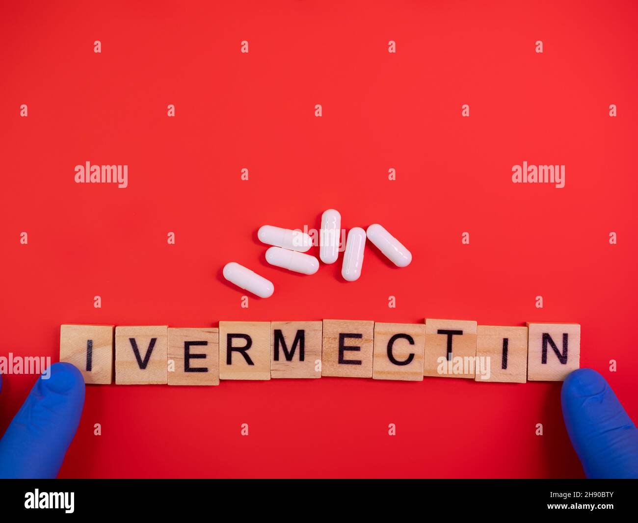 Ivermectin on colored red paper texture background. Ivermectin ...