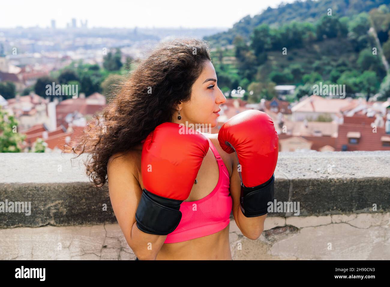 Photo of strong fitness woman boxer in gloves posing outdoors Stock ...