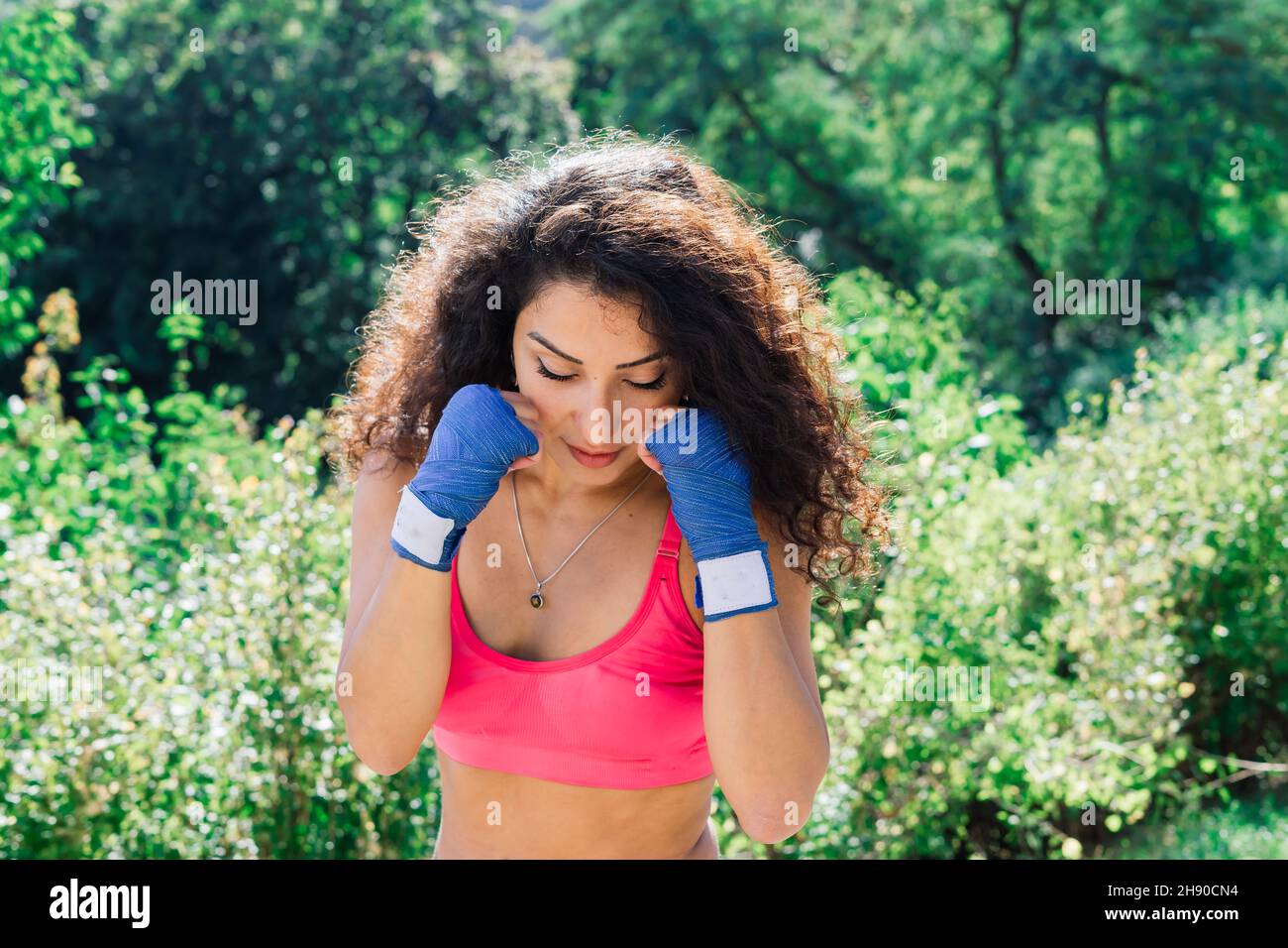 Photo of strong fitness woman boxer in gloves posing outdoors Stock ...