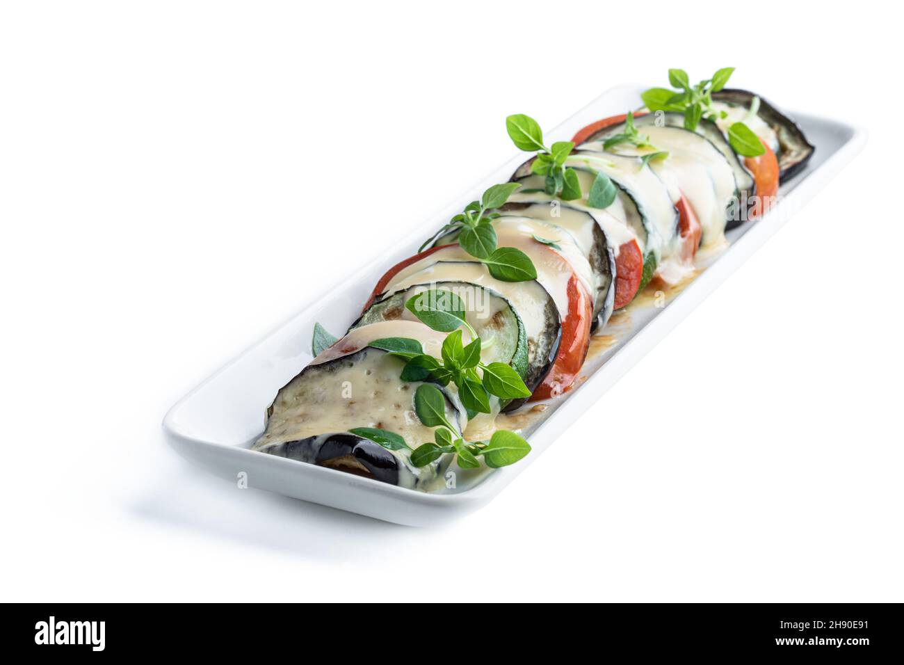 Baked vegetables with cheese and greek basil isolated on white Stock ...