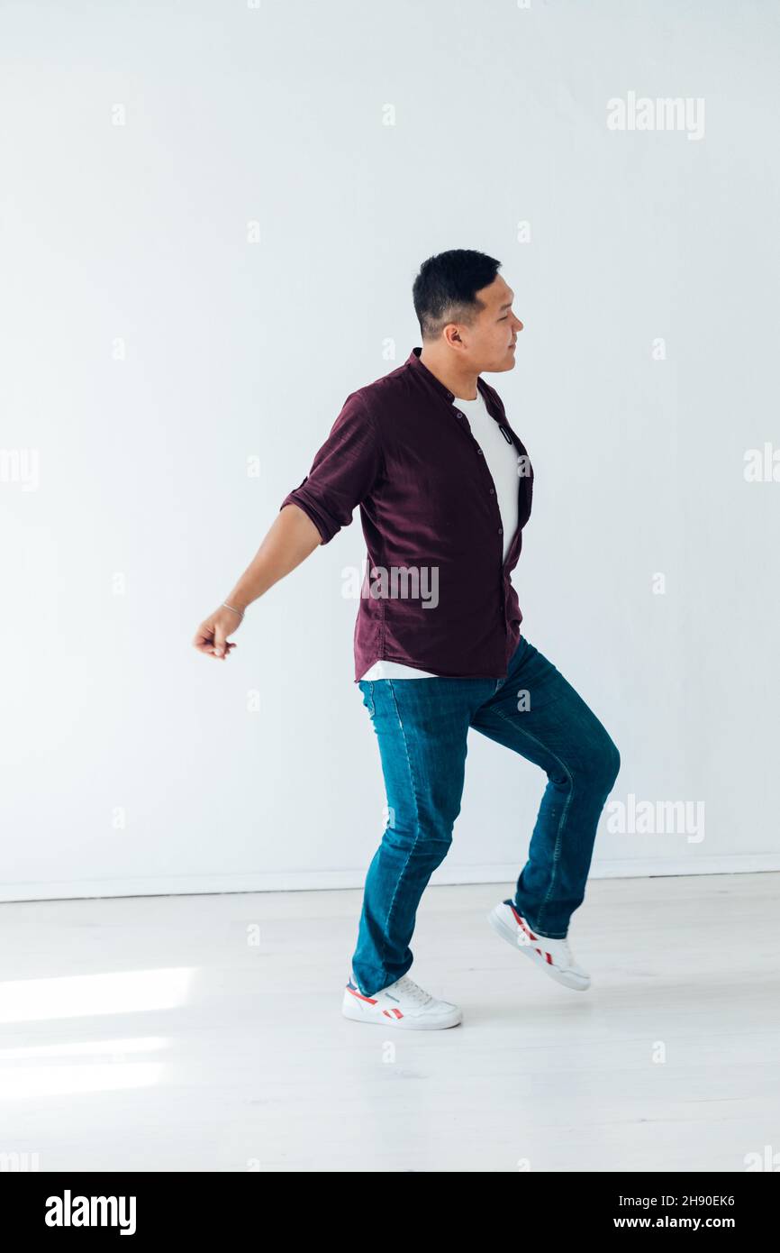 Asian man dancing to music alone at home Stock Photo - Alamy