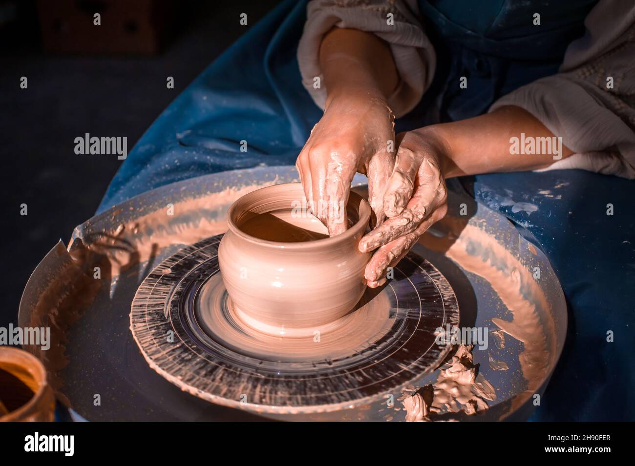 Young lady enjoying pottery art and production process. Artisan ...