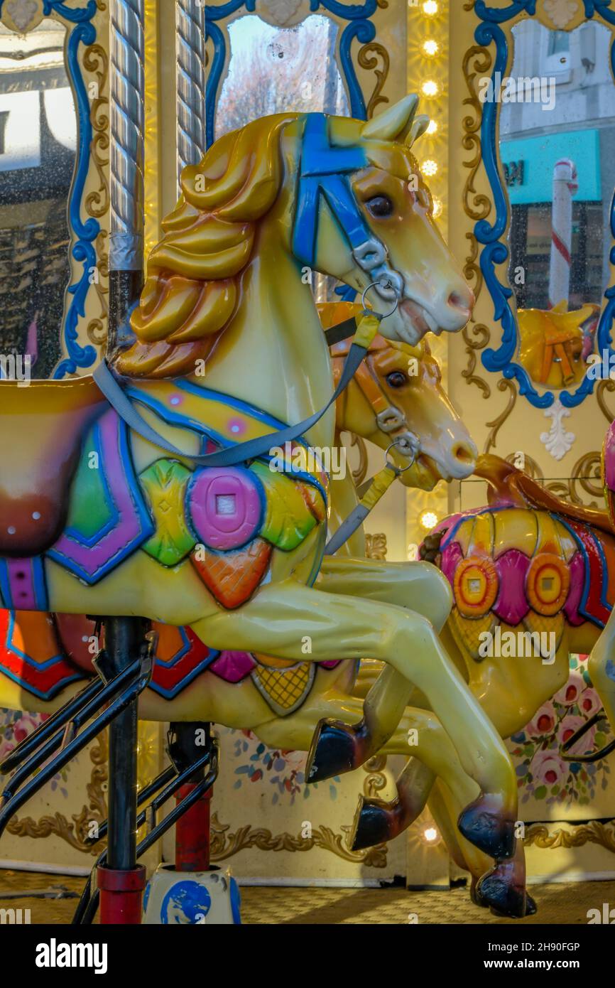 colourful fairground carousel horses painted in gold and bright colours ...