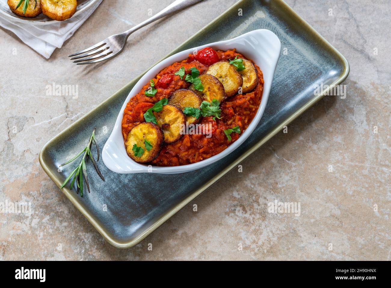 Jollof rice with deep fried plantain - spicy vegetarian African rice ...