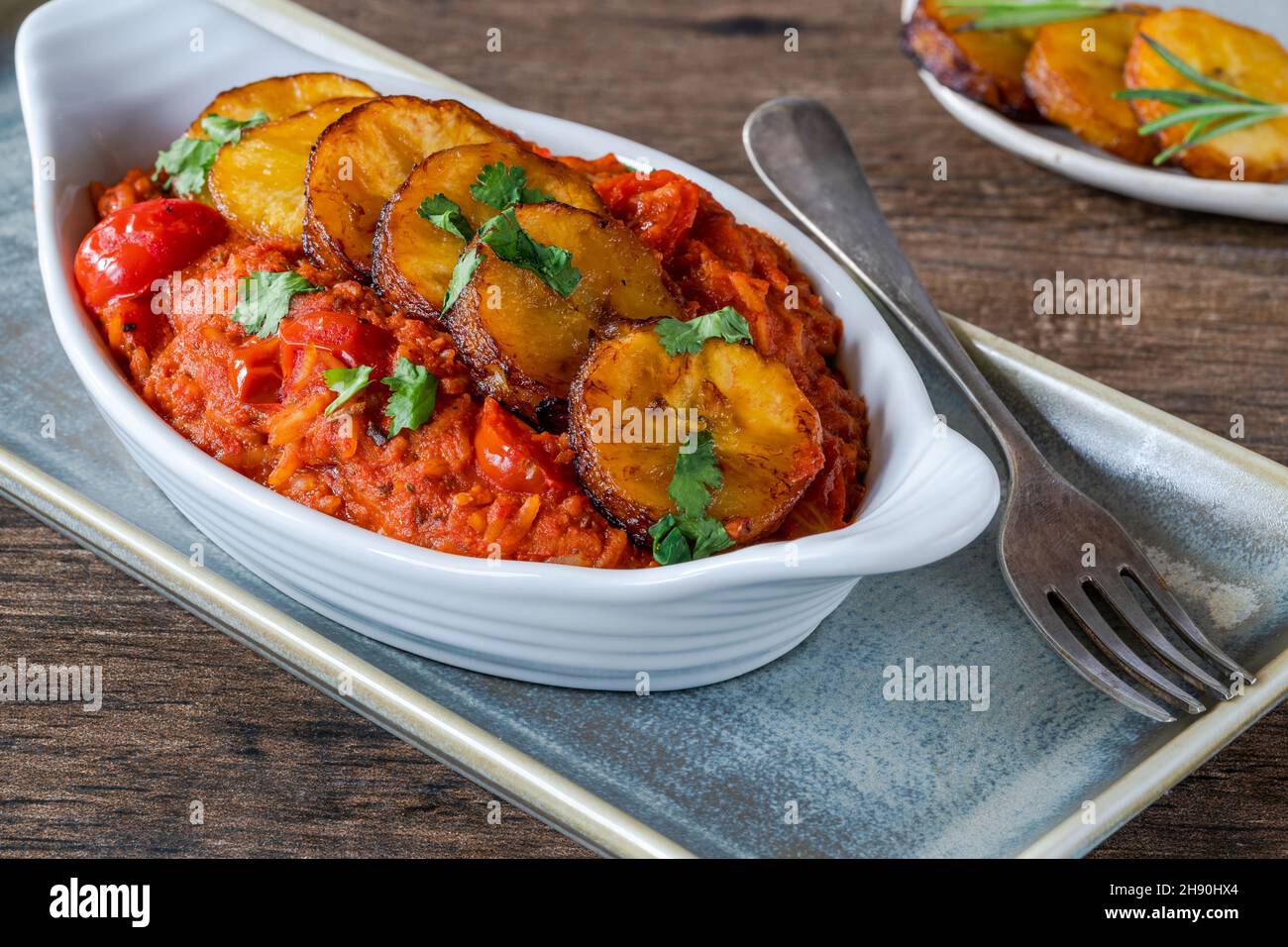Jollof rice with deep fried plantain - spicy vegetarian African rice ...