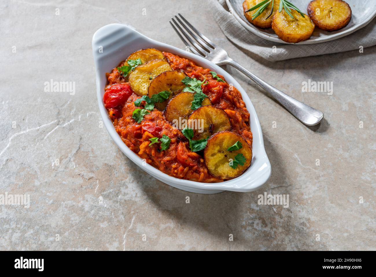 Jollof rice with deep fried plantain - spicy vegetarian African rice ...