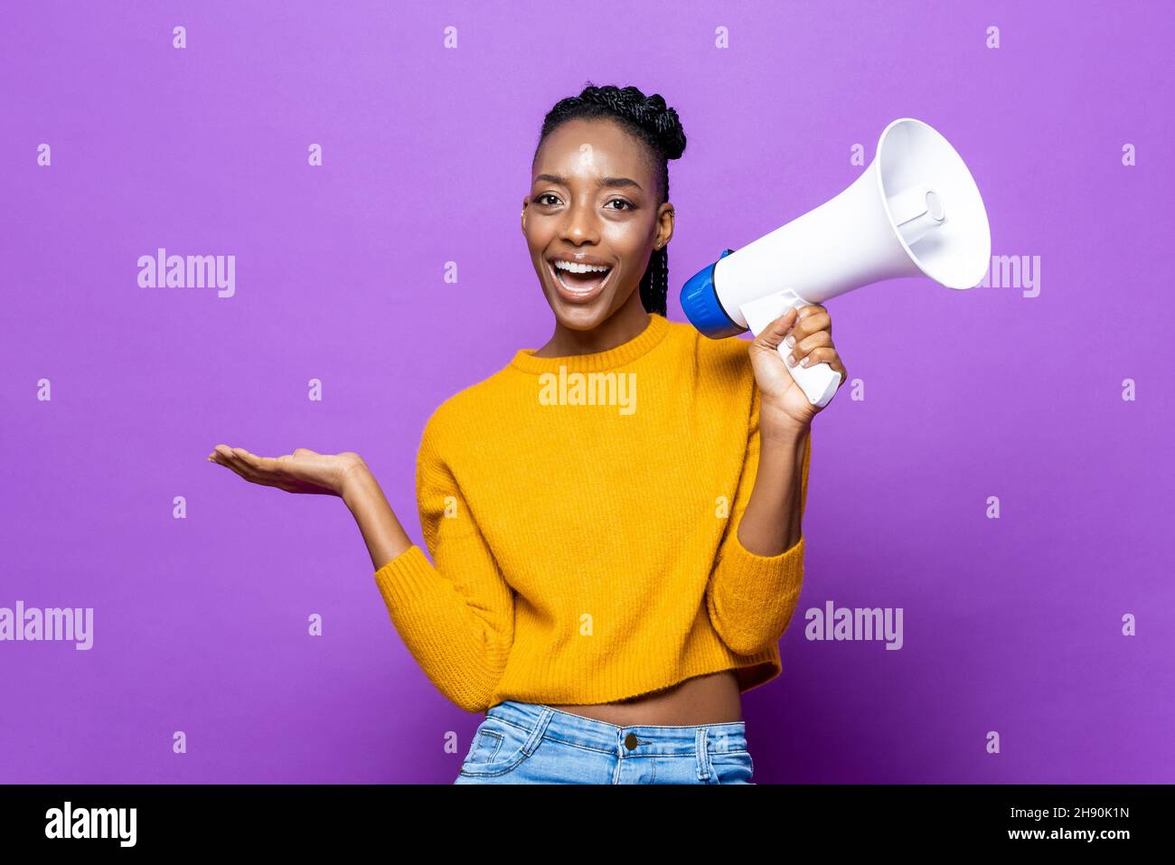 Portrait Of Smiling African American Woman Holding Megaphone And