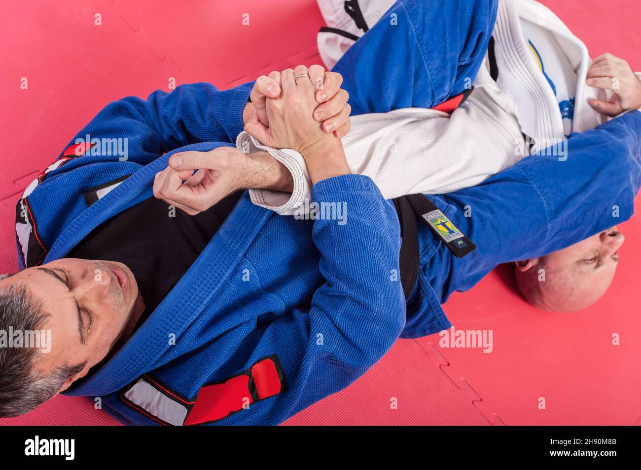 Brazilian jiu jitsu training in traditional kimono. Parterre and ground ...