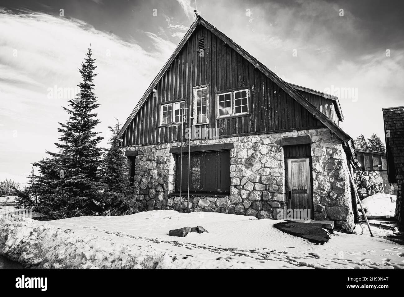 Grayscale of a mountain lodge cabin under a bright sunny sky Stock ...