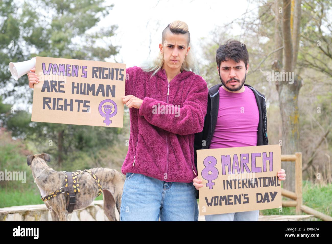 Serious feminist holding protests banners with feminist slogans Stock ...