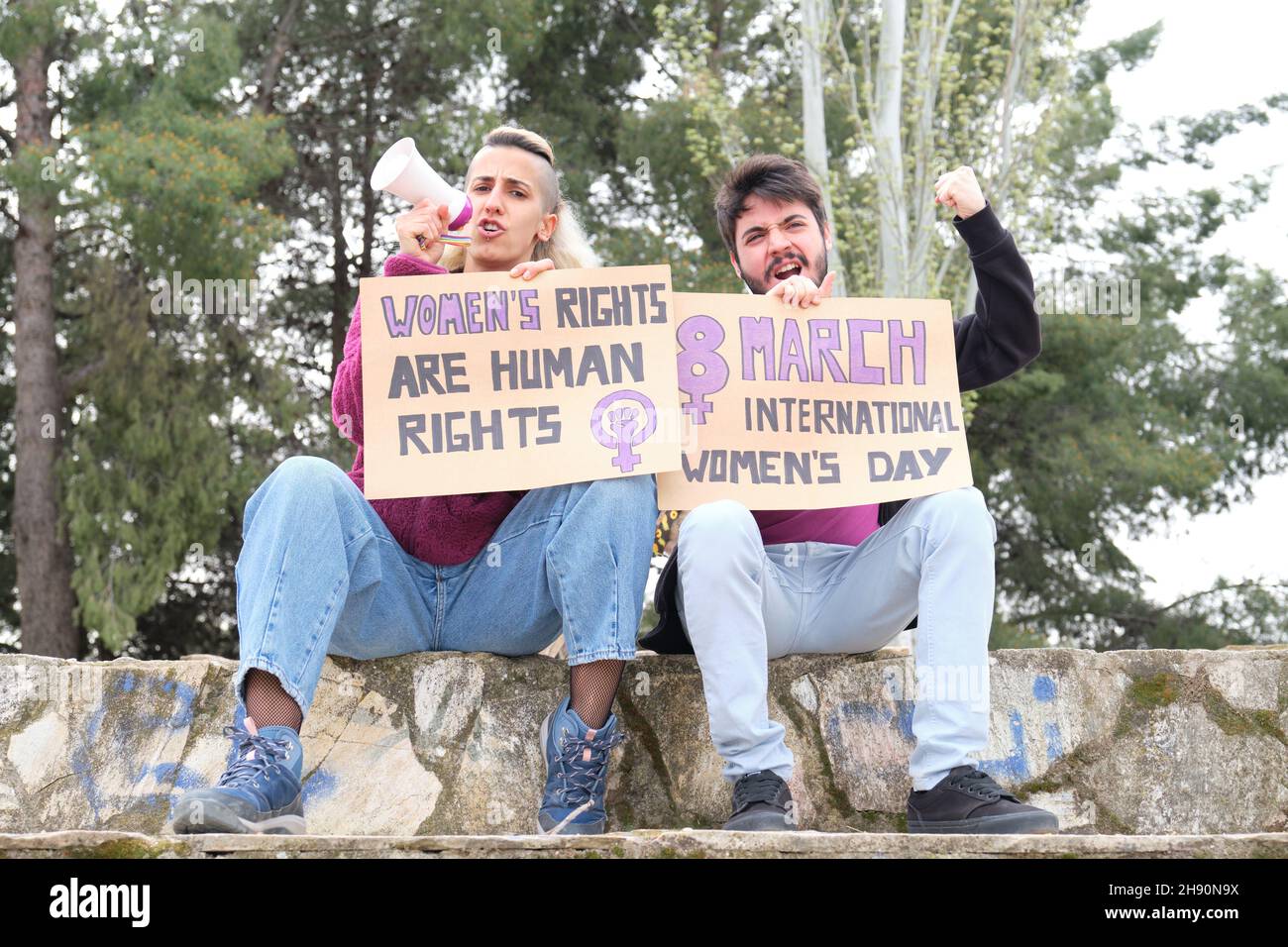 Feminist holding protests banners with feminist slogans and shouting ...