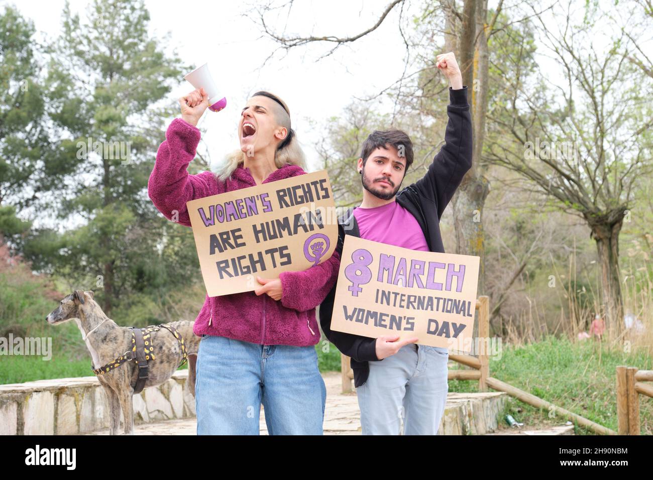 Feminist holding protests banners with feminist slogans and shouting ...