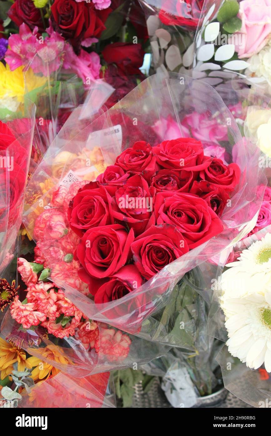 Beautiful bouquet of fresh cheerful bright red roses and flowers Stock ...