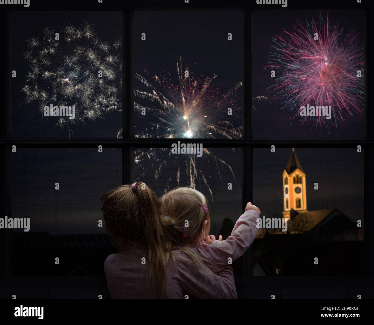 View through window of two Kids watching fireworks , Happy new year ...