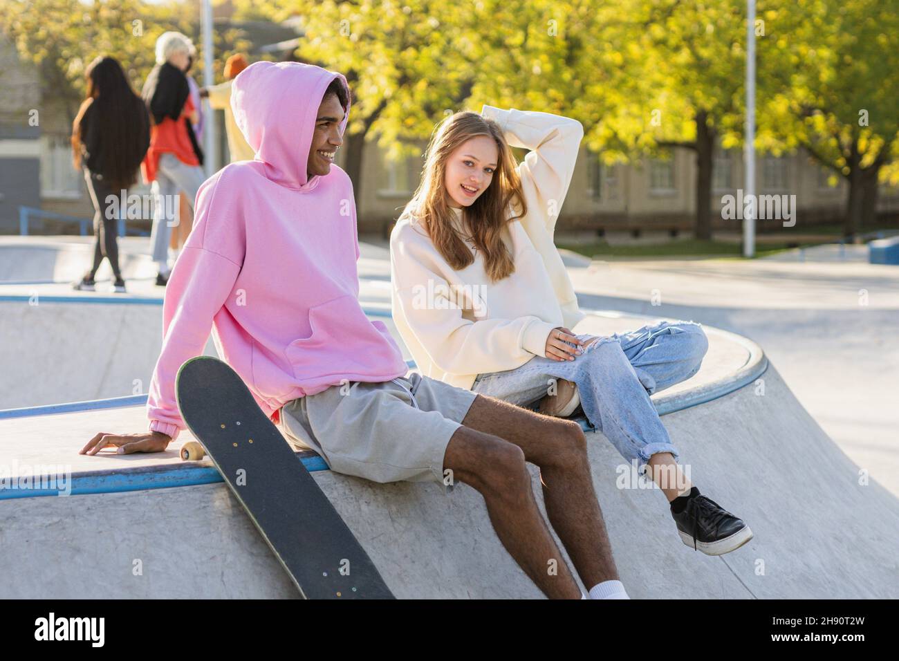 Happy friends sitting skatepark hi-res stock photography and images - Alamy
