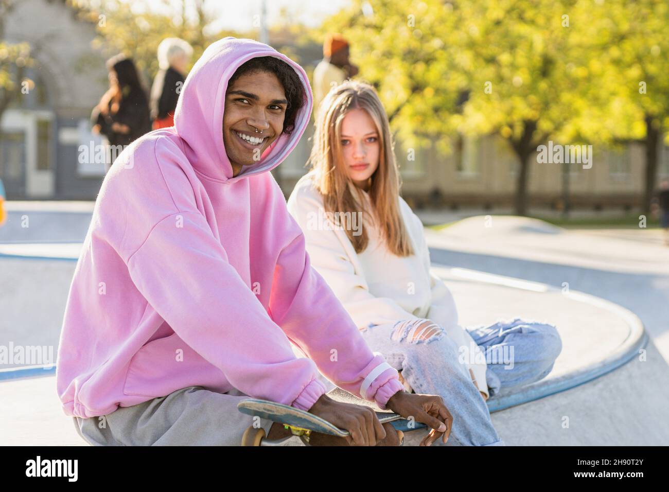 Happy friends sitting skatepark hi-res stock photography and images - Alamy