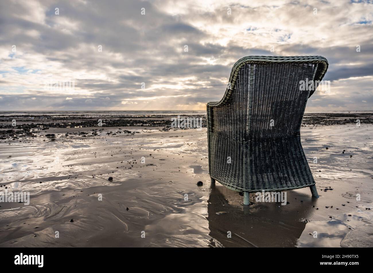 Discarded, unwanted old chair on a deserted beach in the UK. Abandoned ...