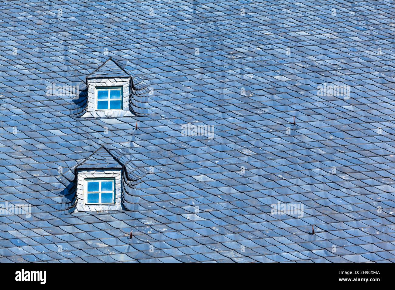 Steep large slate roof with two small dormer windows (copy space Stock ...