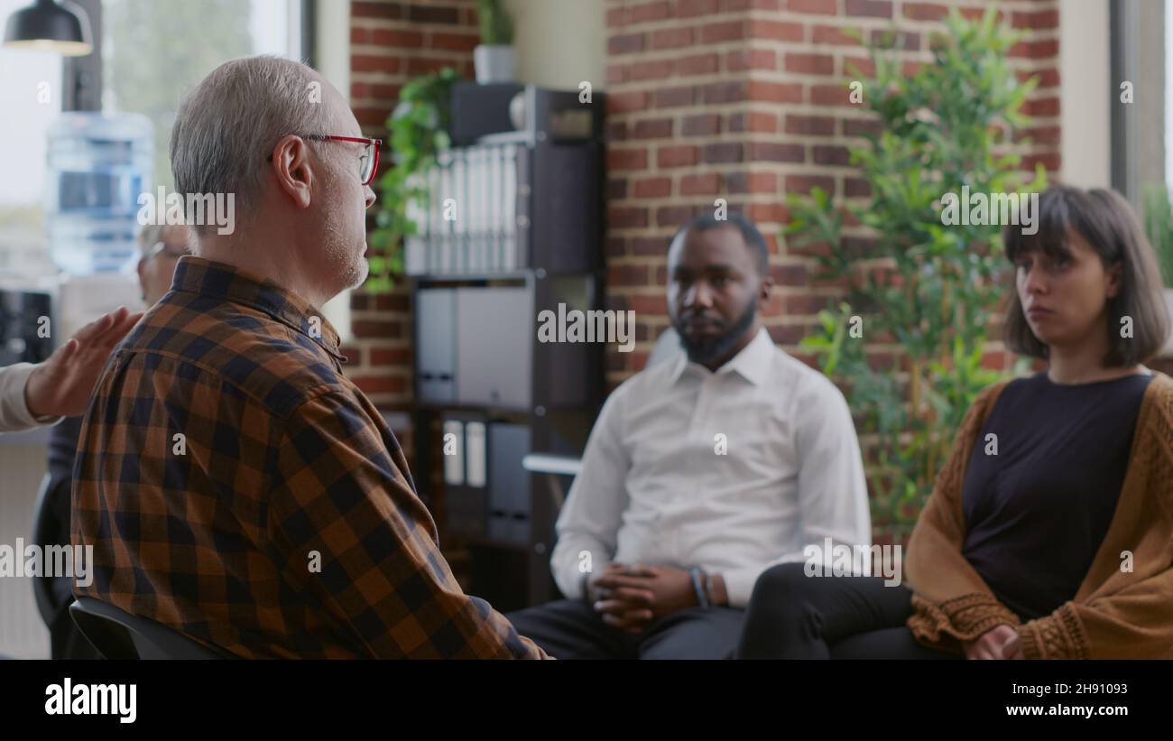 Old man making confession about alcoholism and depression in front of ...