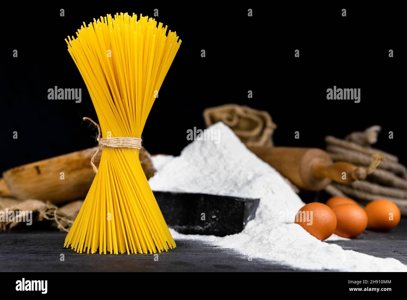 Fresh uncooked Spaghetti and pasta ingredients on a rustic table ...