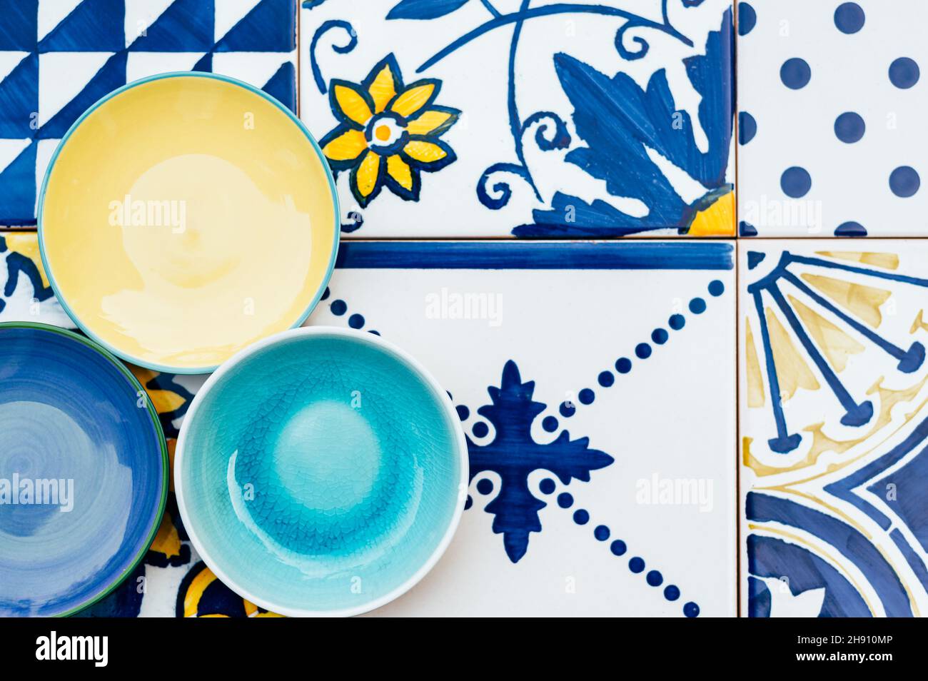 Plates on tile background Stock Photo - Alamy