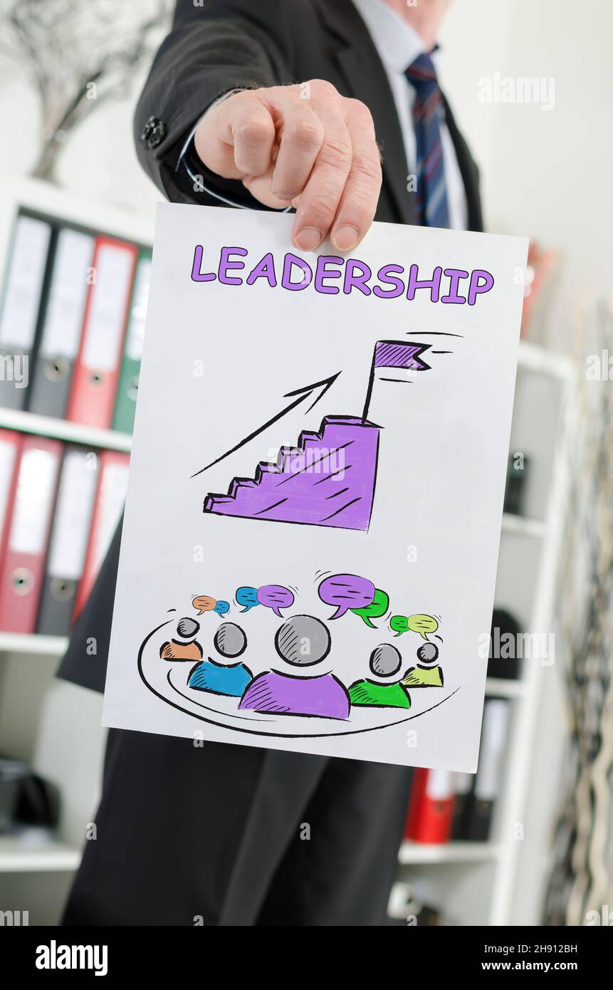 Paper showing leadership concept held by a businessman Stock Photo - Alamy