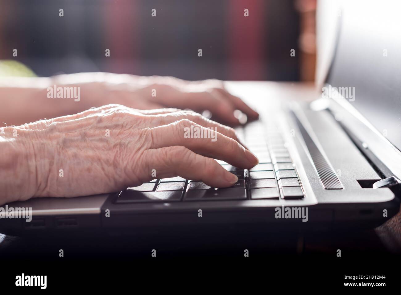 Old woman hands typing on a laptop keyboard Stock Photo - Alamy