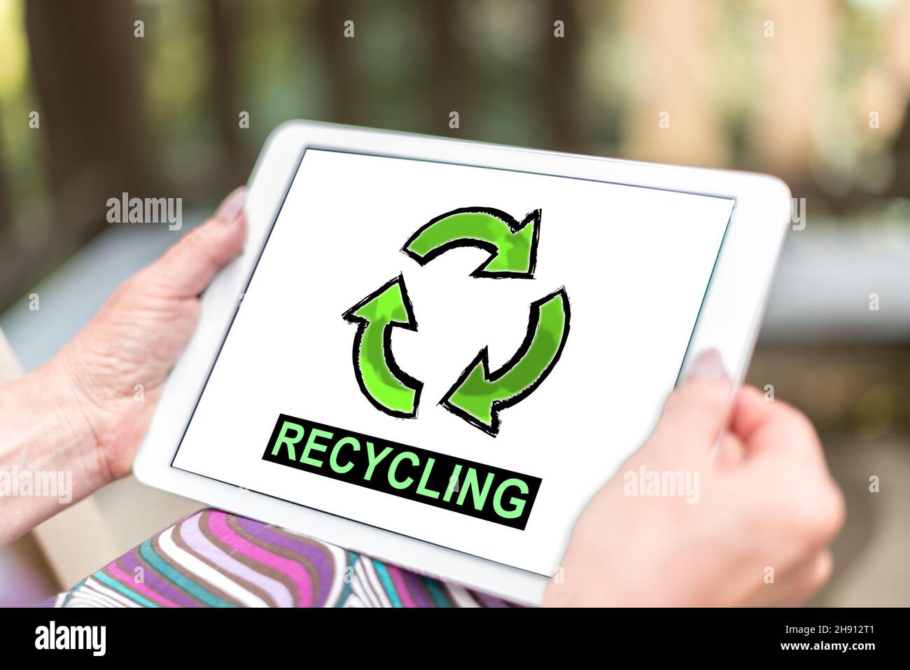 Female hands holding a tablet with recycling concept Stock Photo - Alamy