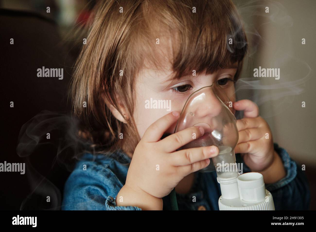 Baby girl in a mask, treatments respiratory tract with a nebulizer at ...