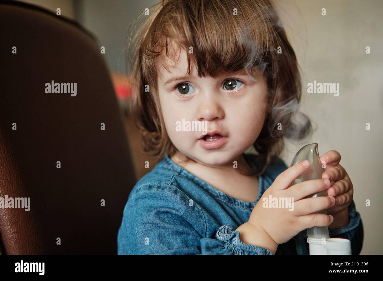 Baby girl in a mask, treatments respiratory tract with a nebulizer at ...